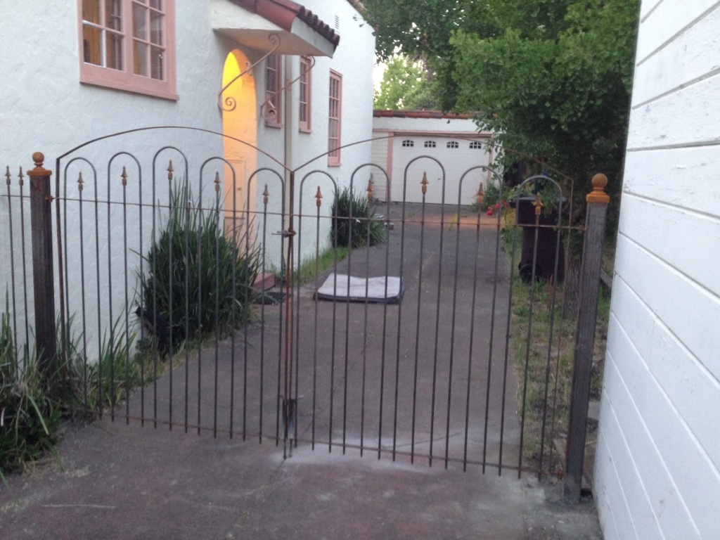 Two Arched Gates Cover Arched Driveway