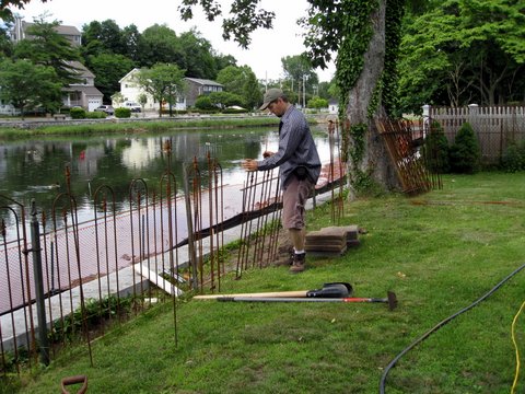 Customer Installing our No-Dig Fencing