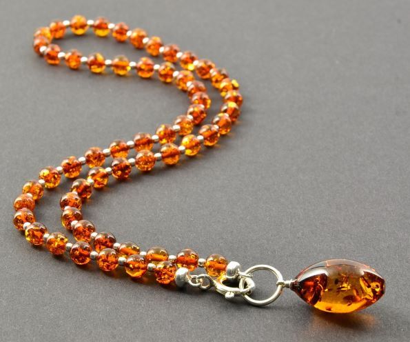 Amber Pendant Necklaces Adorned with Sterling Silver Spacers.